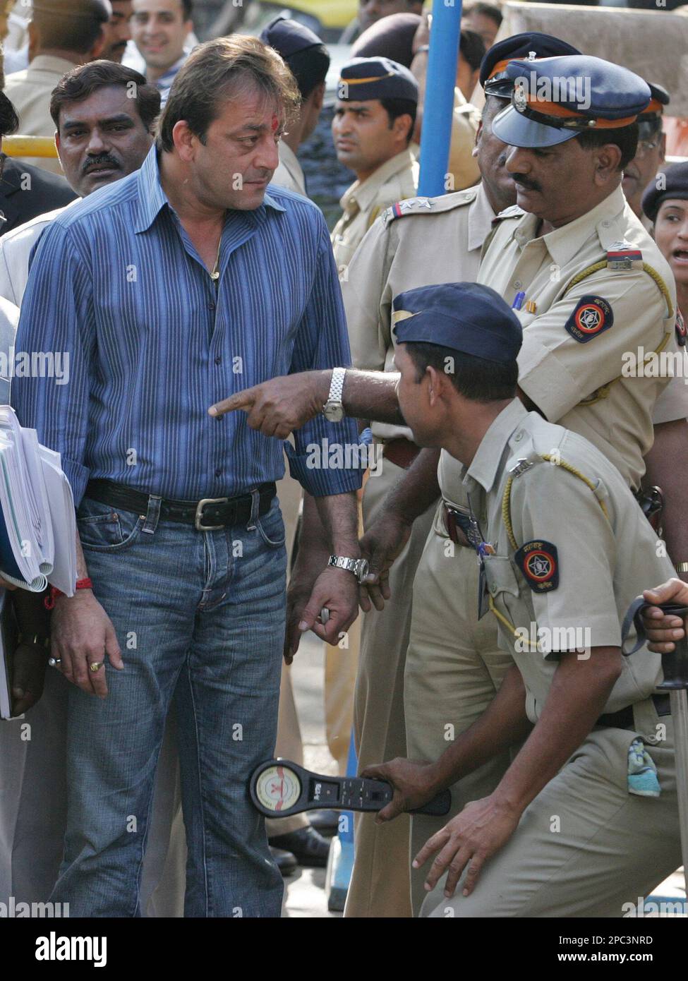 Police check Bollywood actor Sanjay Dutt, left, as he arrives to appear ...