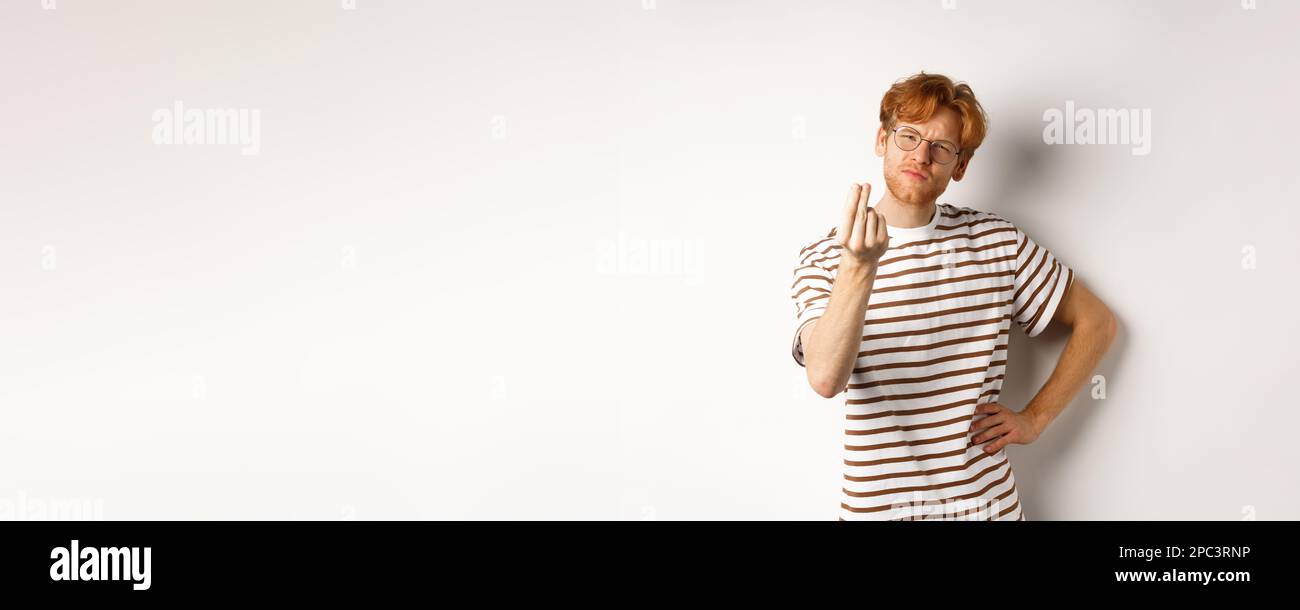 Image of satisfied young man with red hair and glasses showing chefs ...