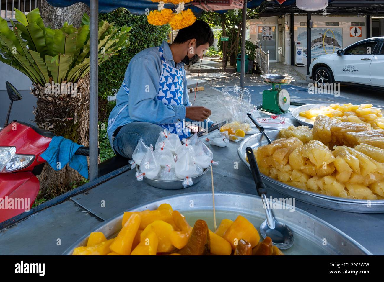 A young man selling sweet fruits from a cart. Bangkok, Thailand Stock ...