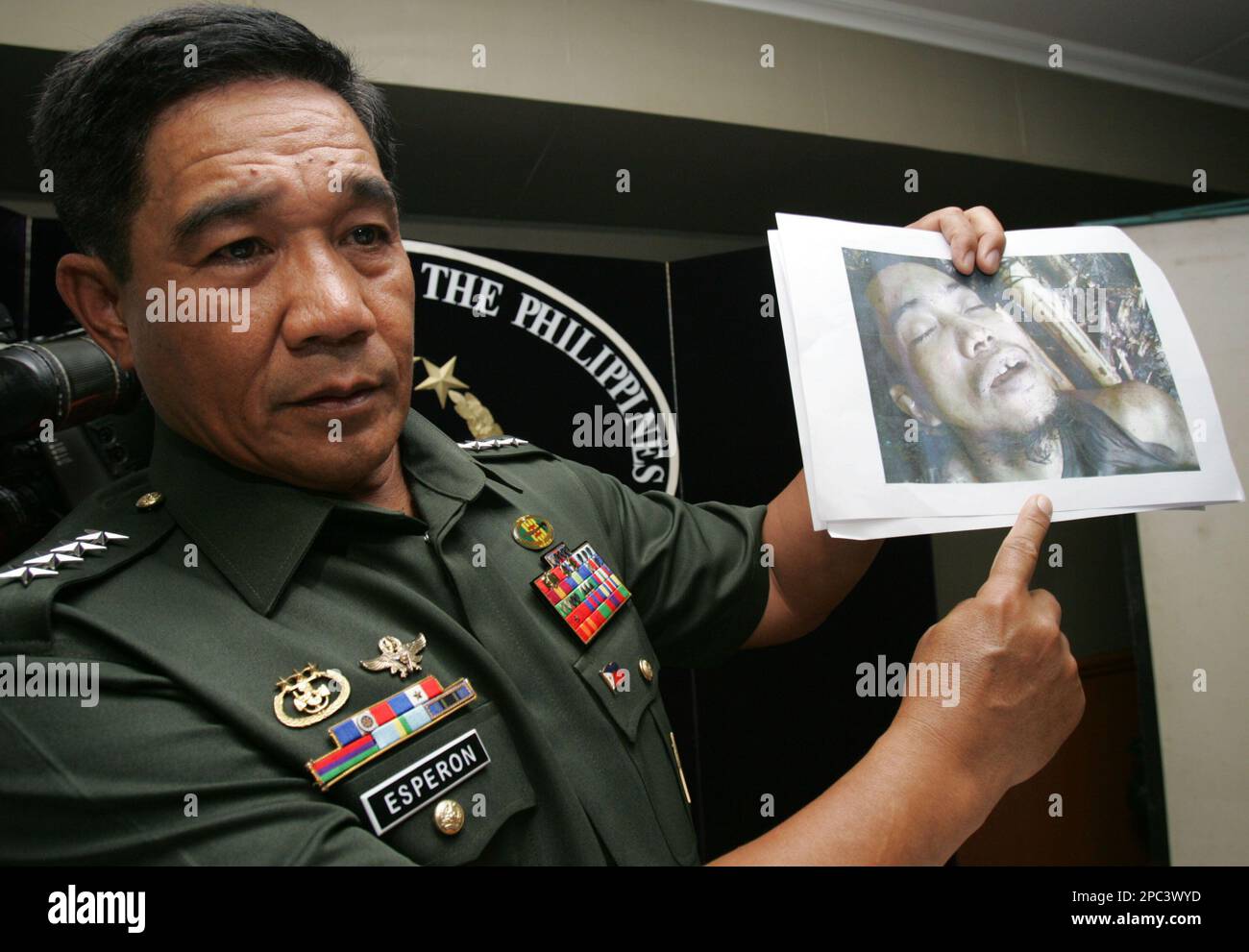 Philippine Armed Forces Chief Gen. Hermogenes Esperon Jr. shows a photo ...