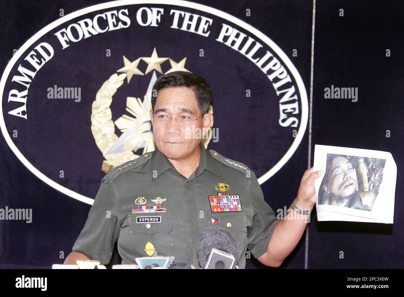 Philippine Armed Forces Chief Gen. Hermogenes Esperon Jr. shows a photo ...