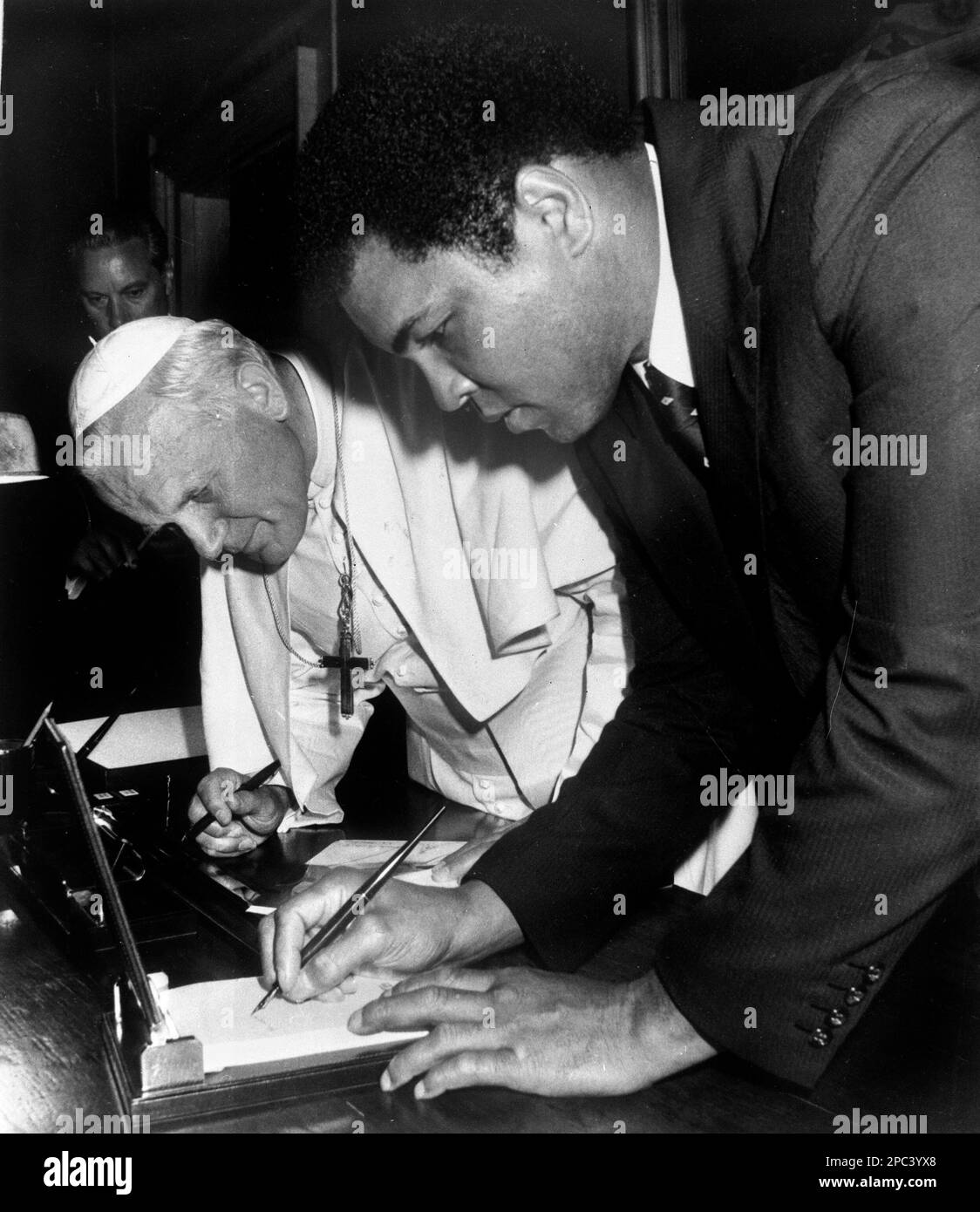 ** FILE ** Pope John Paul II looks on as Muhammad Ali, former ...
