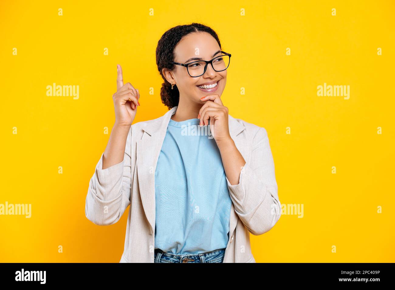 Joyful excited brazilian business woman, with glasses, holds her hand ...
