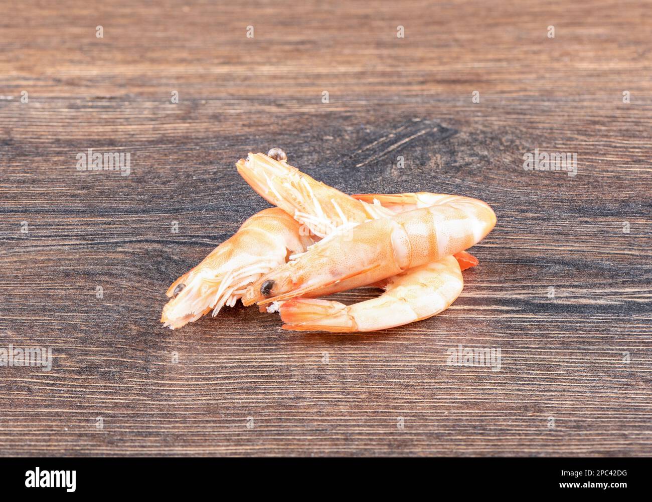 Cooked whole fresh shrimp on wooden background with copy space. Healthy ...