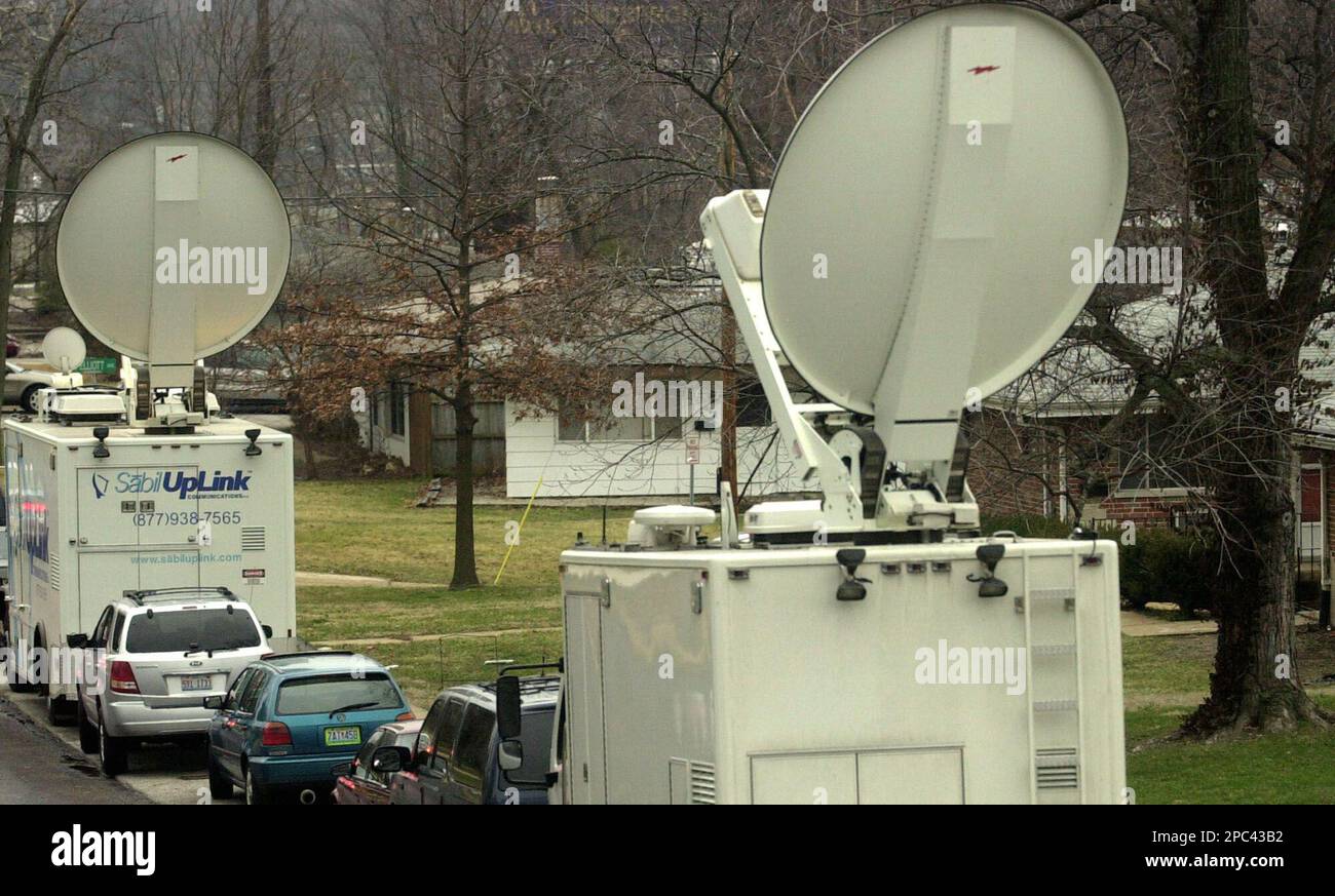 News media continue to monitor the building, right, where kidnapping ...