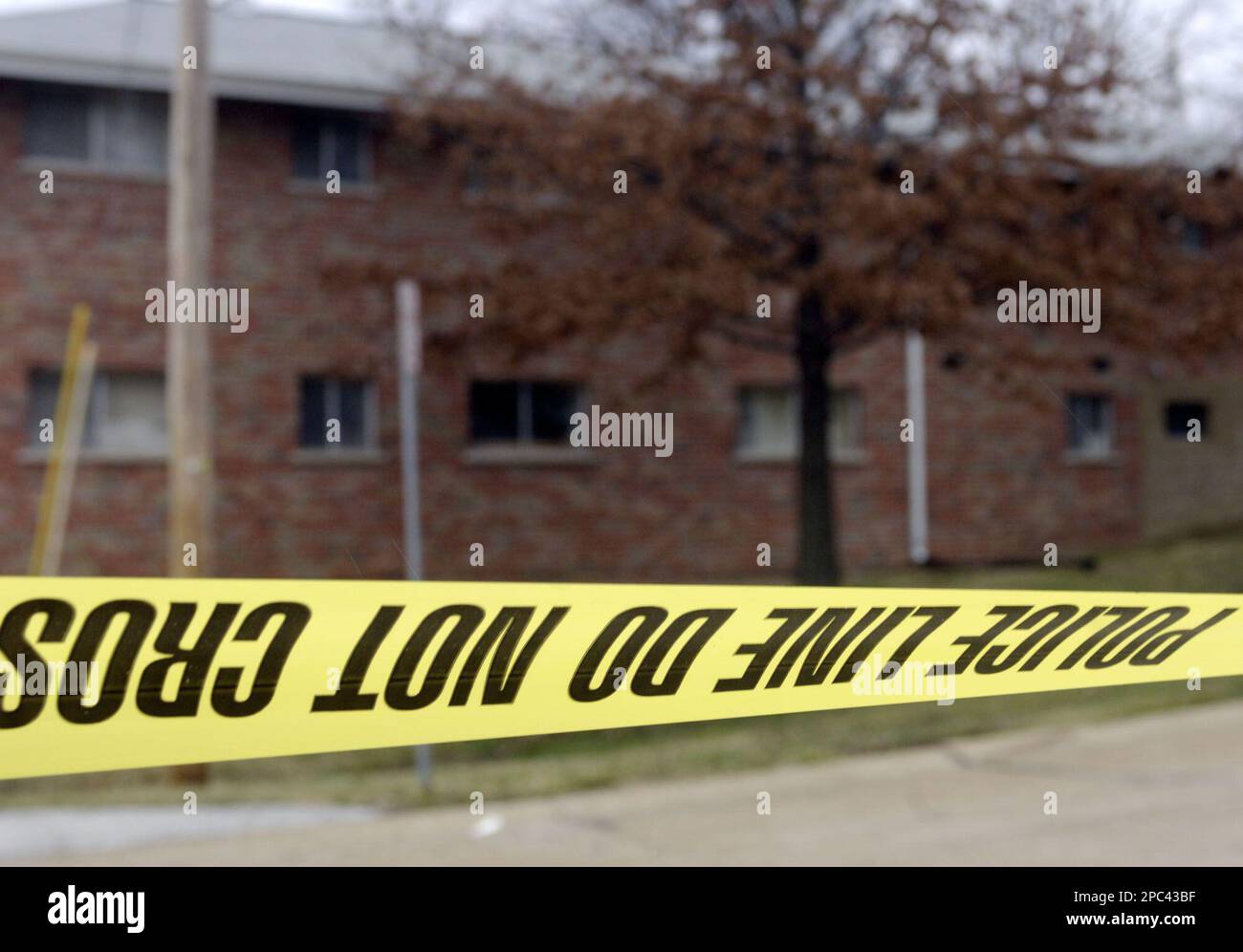 A police tape still blocks a parking lot near the building where ...