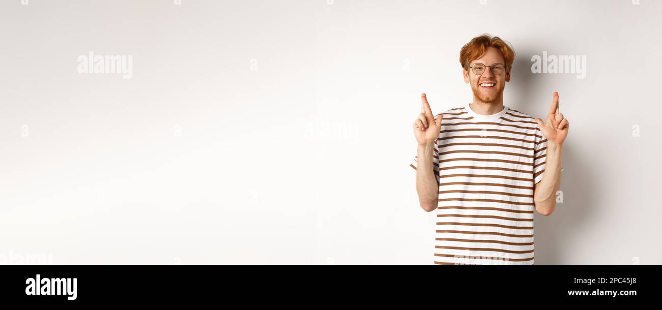 Hopeful and optimistic man with ginger hair and glasses having hope ...