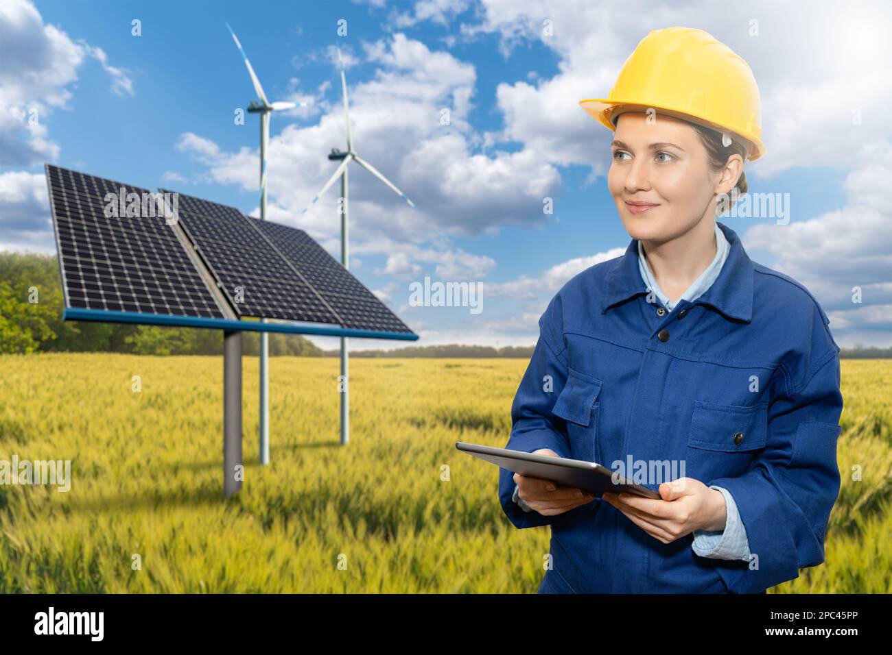 Woman engineer with tablet computer on a background of wind turbines ...