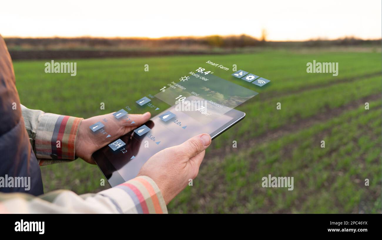 Farmer with digital tablet on an agricultural field. Smart farming and digital agriculture Stock ...