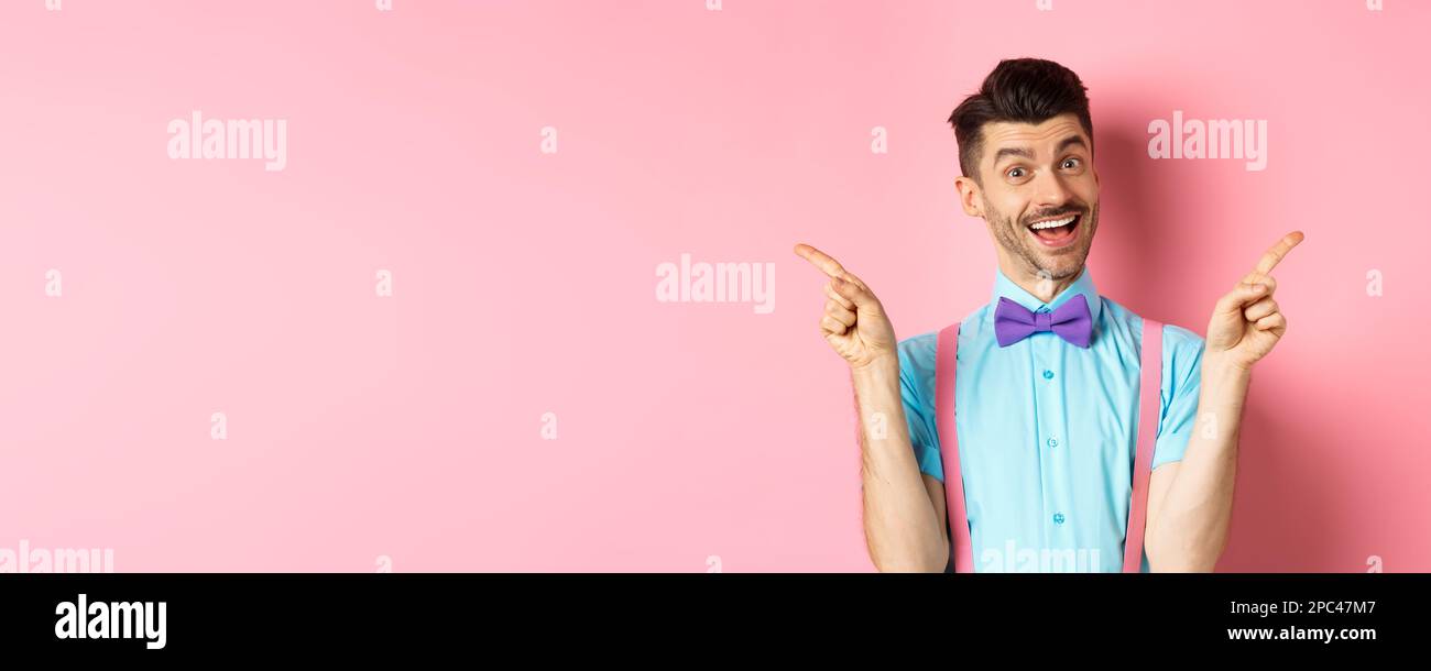 Handsome funny guy pointing fingers aside, showing left and right logo ...