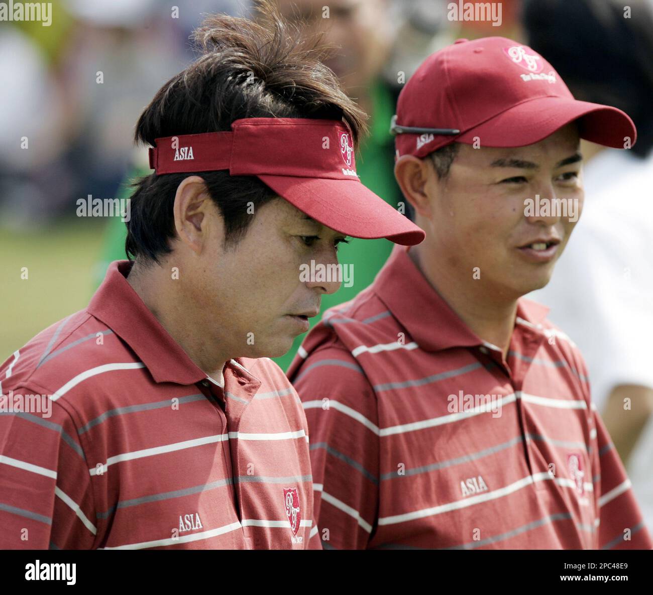 Asian team captain Naomichi "Joe" Ozaki of Japan, left, talks to ...