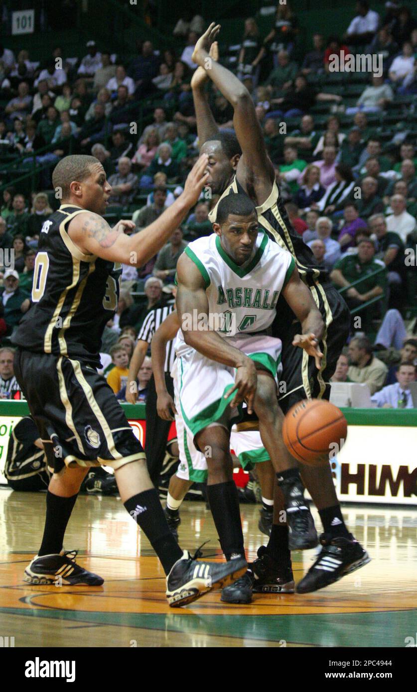 Marshall's Tre Whitted (14) splits the defense of Central Florida's ...