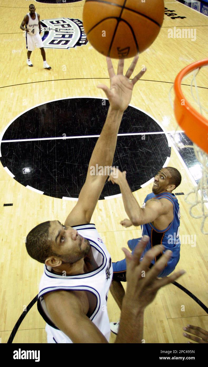 San Antonio Spurs forward Tim Duncan, left, shoots as Washington ...