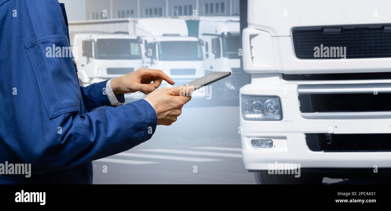 Manager with a digital tablet next to trucks. Fleet management Stock ...