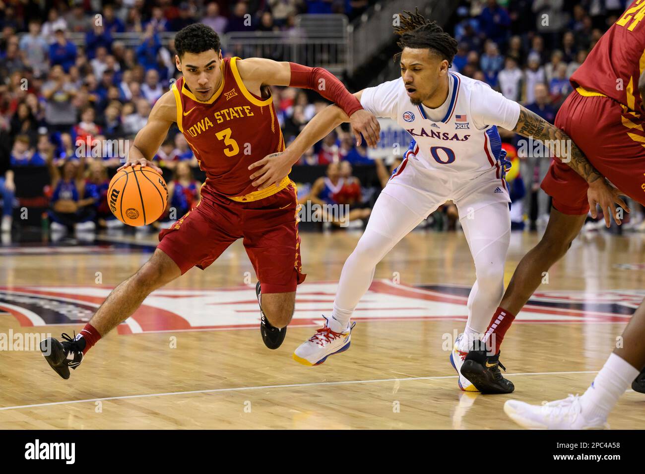 Iowa State guard Tamin Lipsey (3) drives past Kansas guard Bobby Pettiford Jr. (0) during the ...