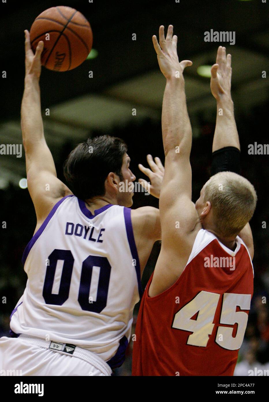 Northwestern's Tim Doyle shoots over Wisconsin's Joe Krabbenhoft during ...