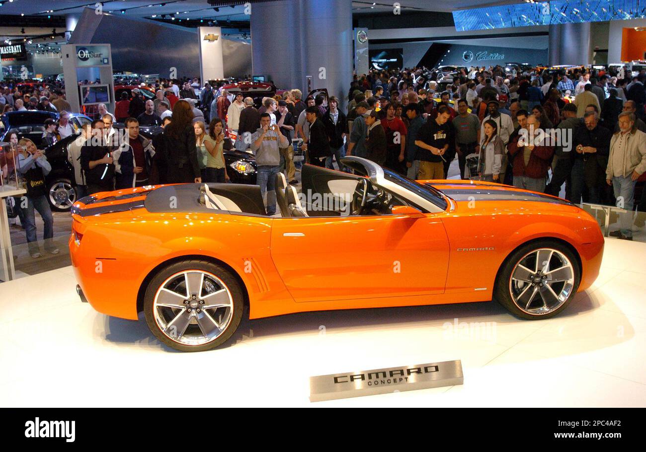 People look over the Chevrolet Camaro concept car on display during ...