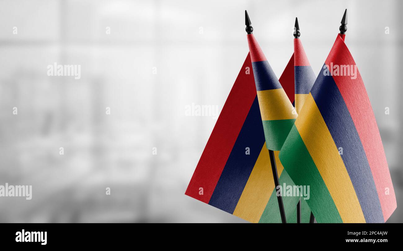 Small flags of the Mauritius on an abstract blurry background Stock ...