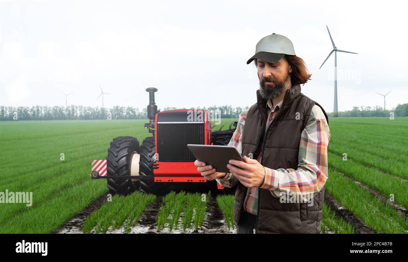 Farmer with digital tablet controls an autonomous tractor on a smart ...