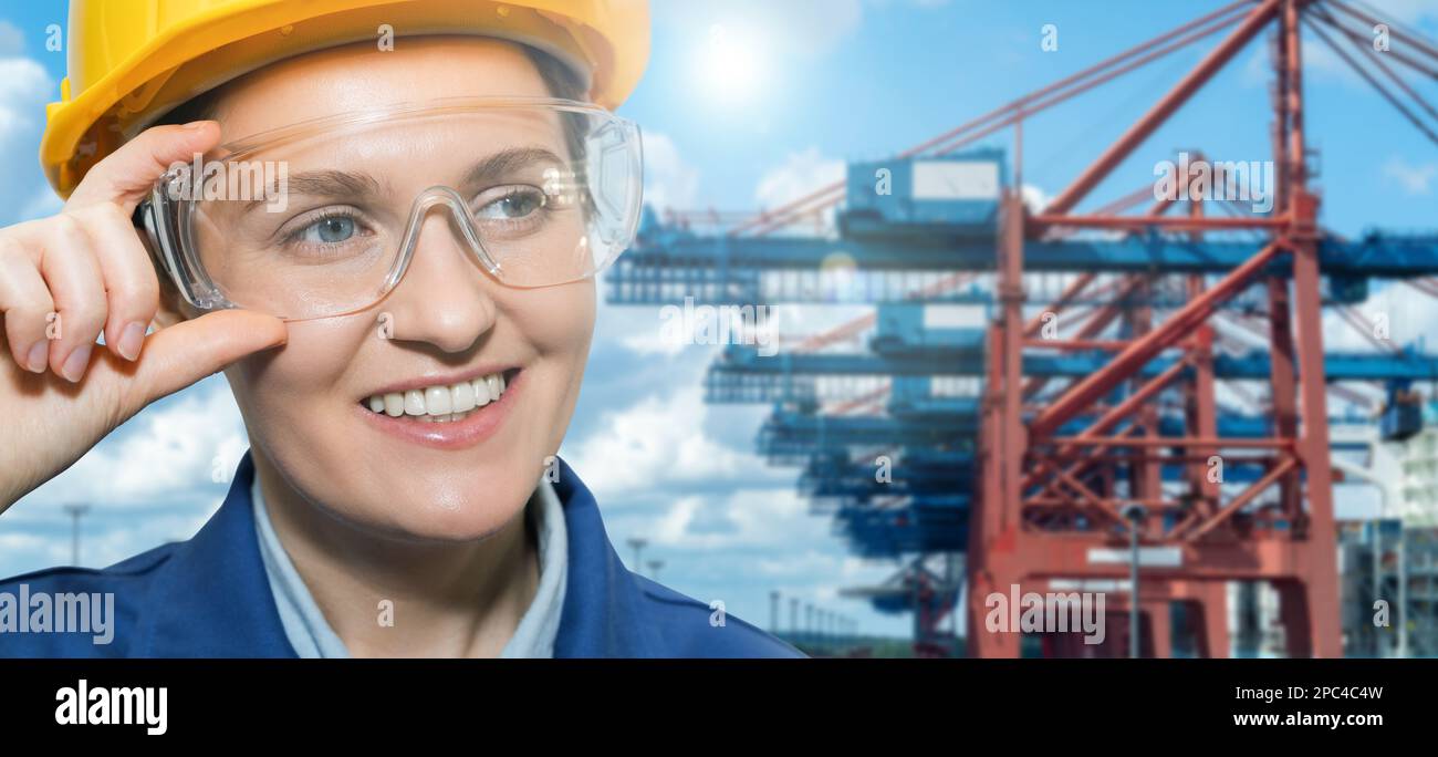 Portrait of woman port manager in helmet and eyeglasses on a background ...