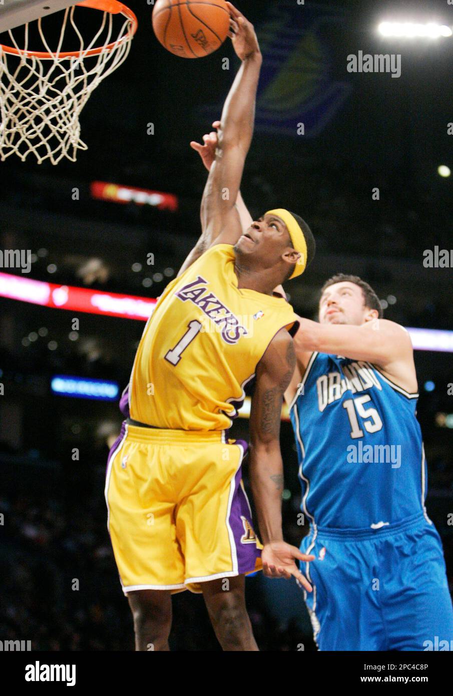 Los Angeles Lakers' Smush Parker, left, goes up to dunk the ball as ...