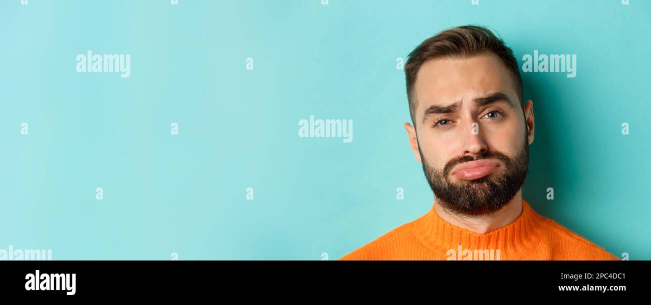 Headshot of sad and gloomy man complaining, pouting and frowning ...