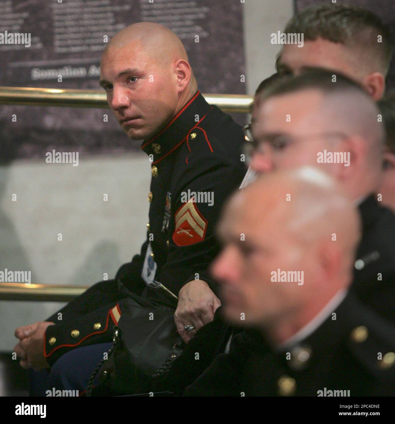 Marine Cpl. William Hampton, left, watches a ceremony at the Pentagon ...