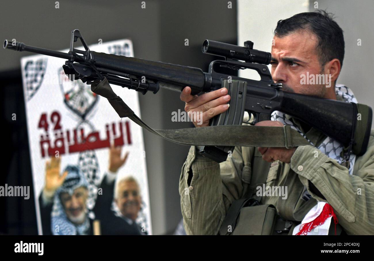 A Palestinian militant from the Al-Aqsa Martyrs Brigades holds his ...