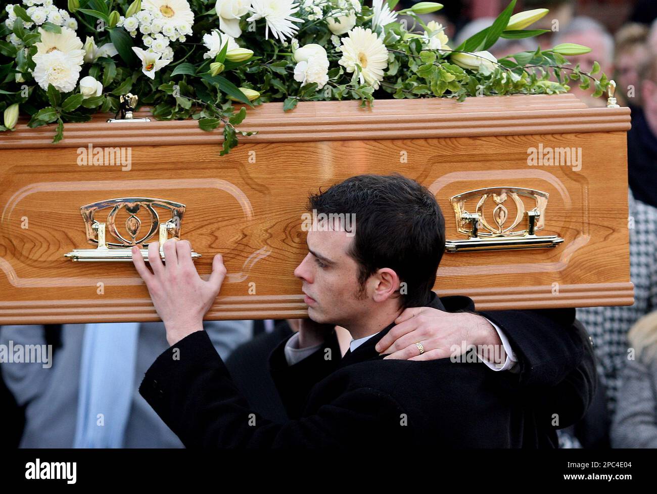 Mark Ervine carries the coffin of his father David Ervine after the ...