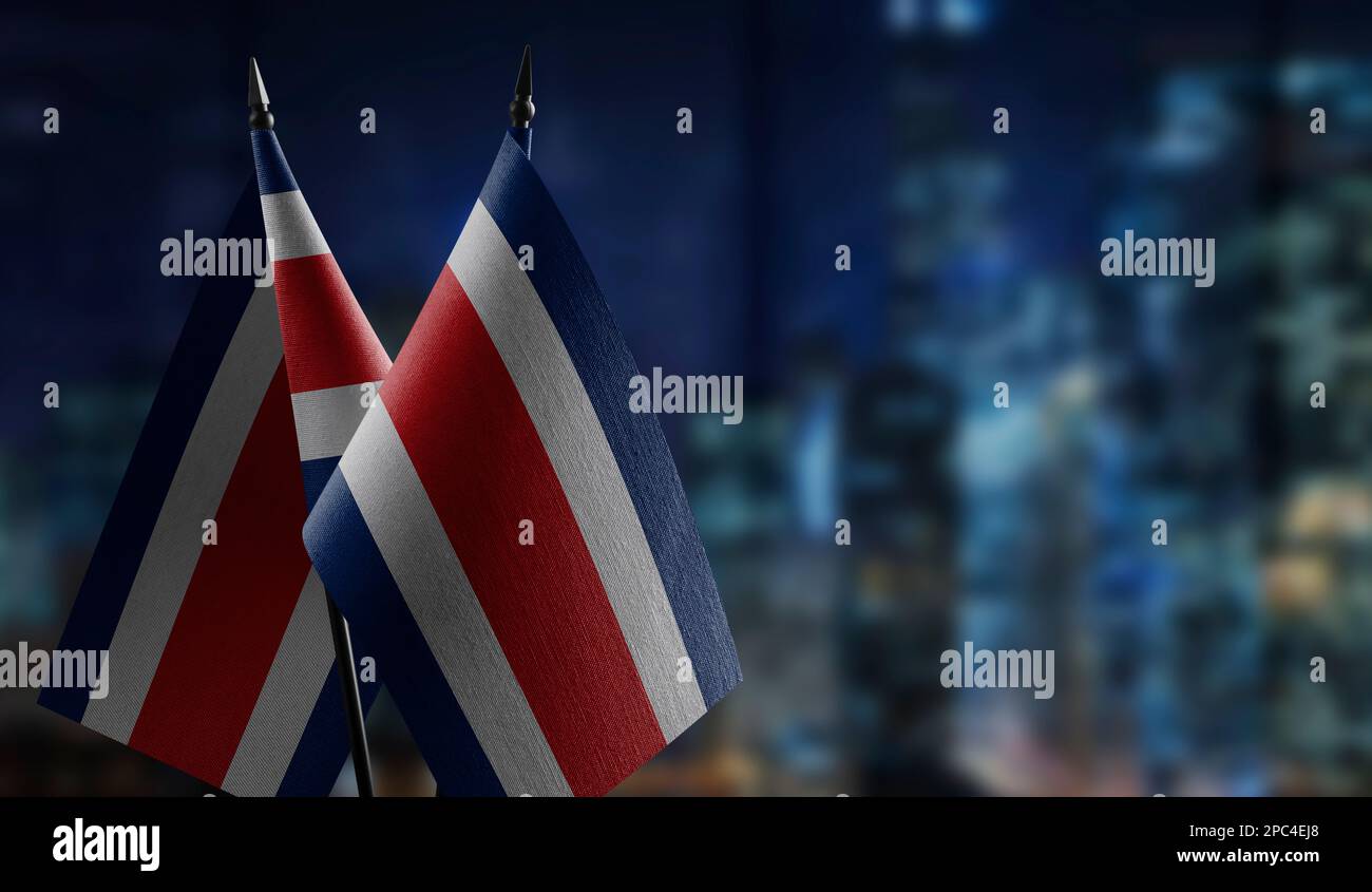 Small flags of the Costa Rica on an abstract blurry background Stock ...