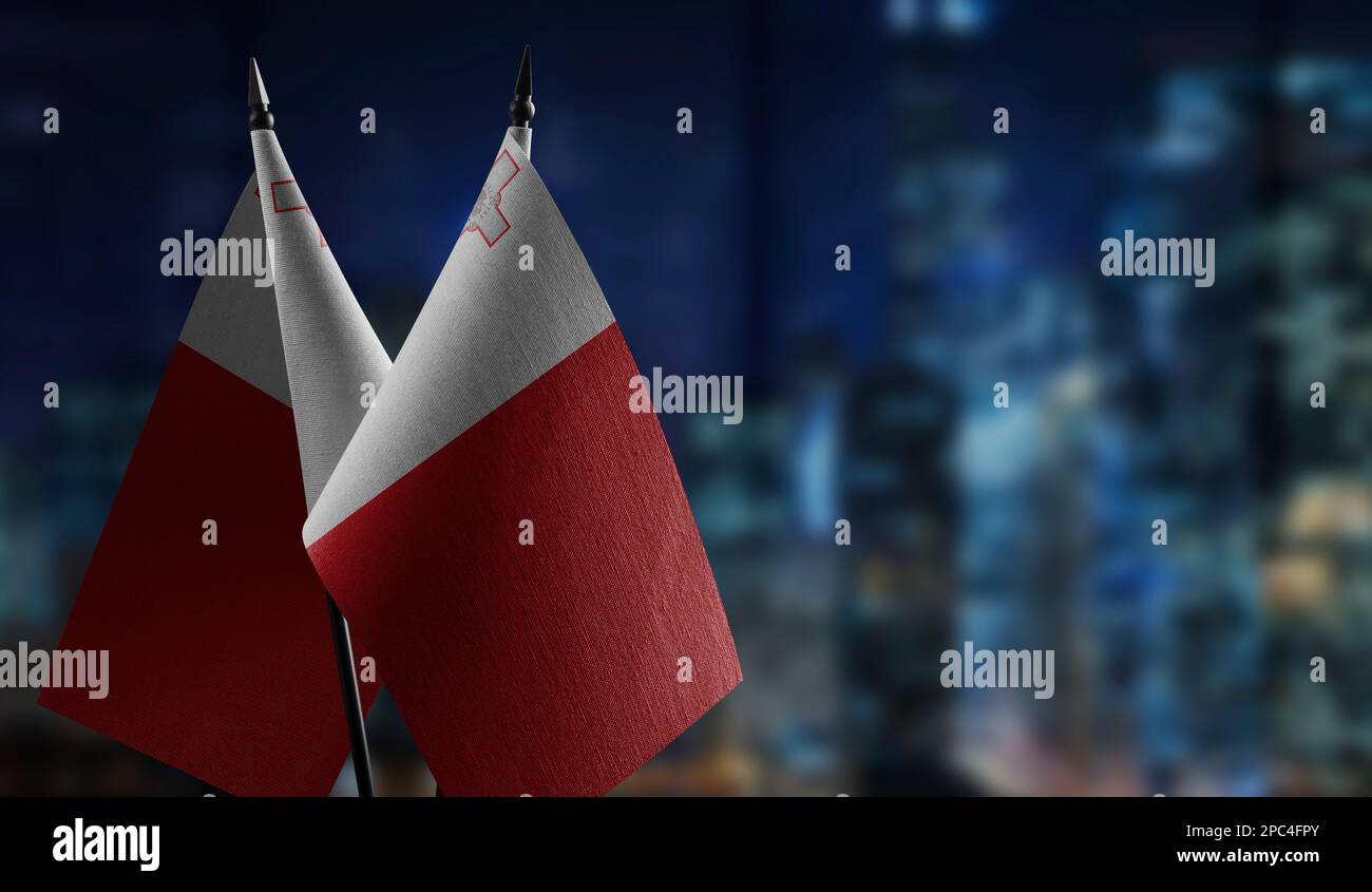 Small flags of the Malta on an abstract blurry background Stock Photo ...