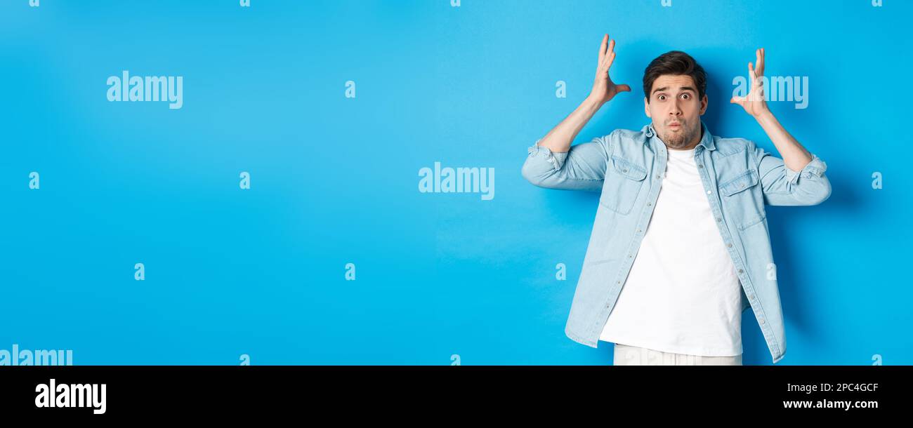 Distressed guy showing mind blowing gesture, looking frustrated and ...