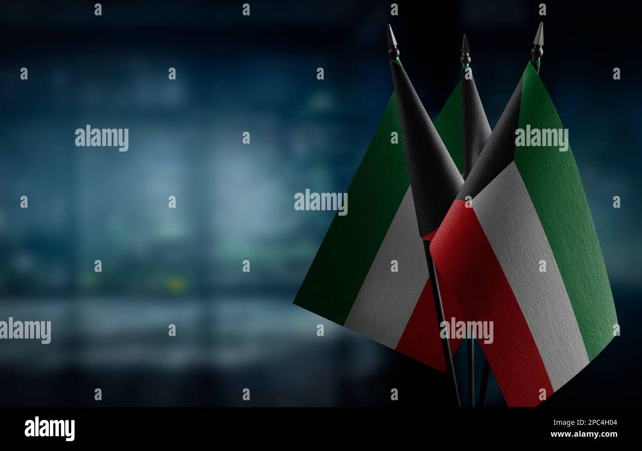Small flags of the Kuwait on an abstract blurry background Stock Photo ...