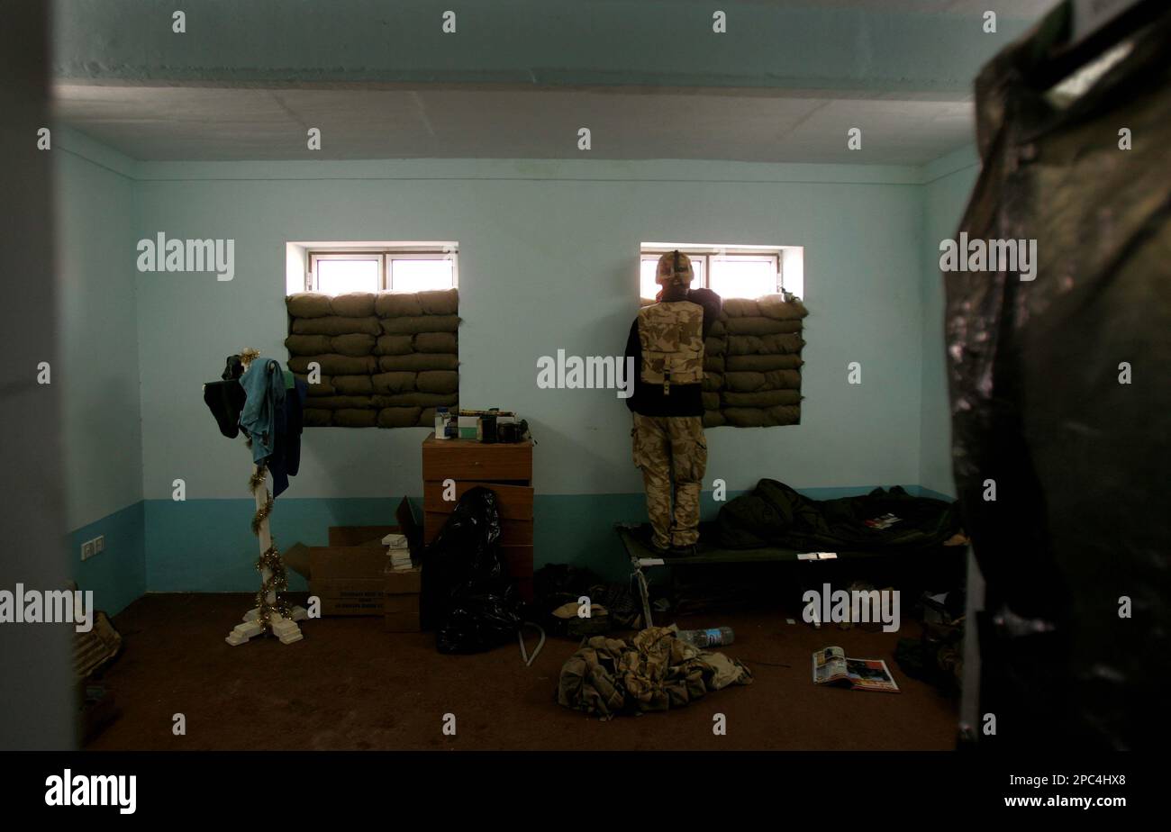 A soldier from 42 Commando British Royal Marines looks out from his ...