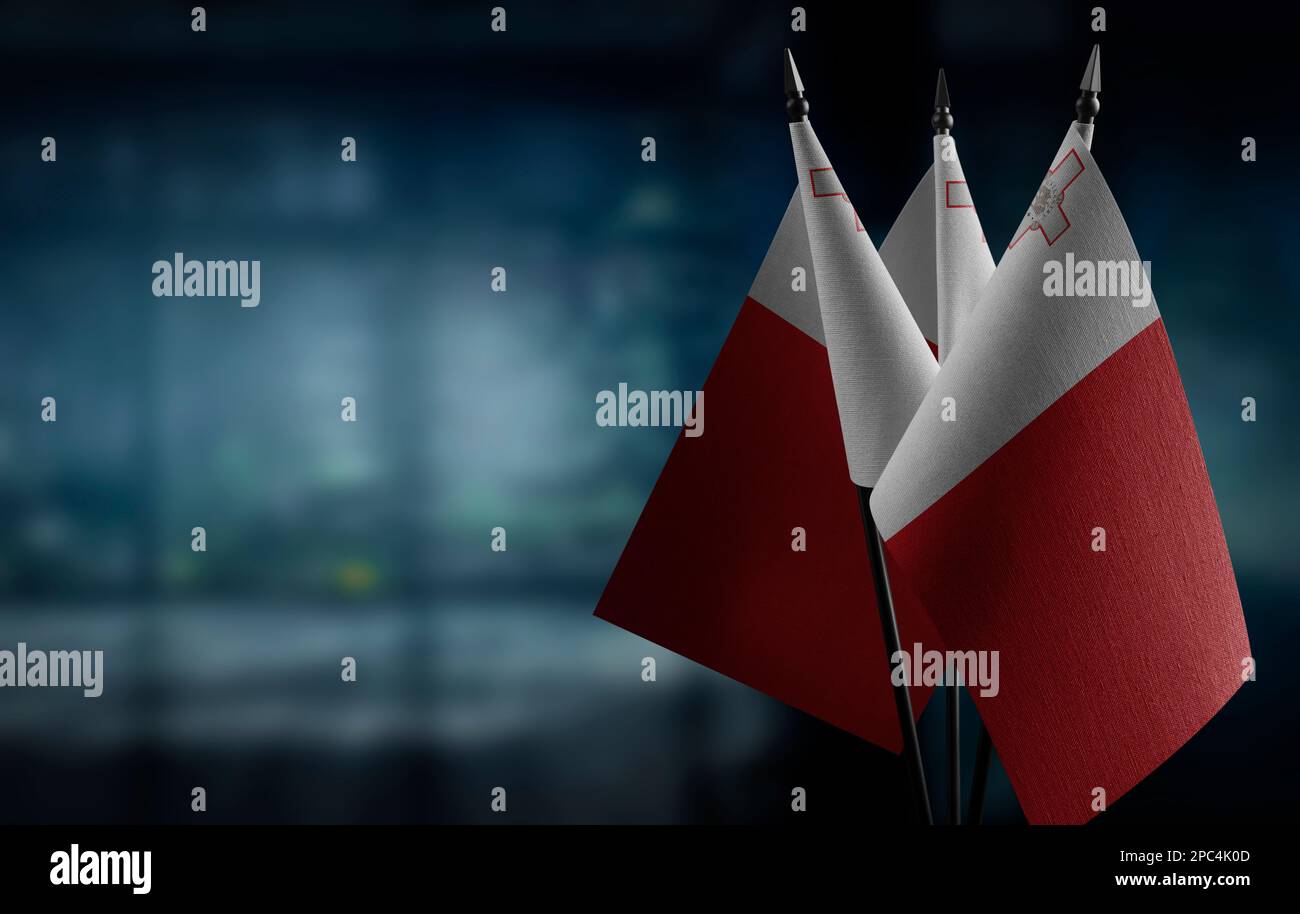 Small flags of the Malta on an abstract blurry background Stock Photo ...