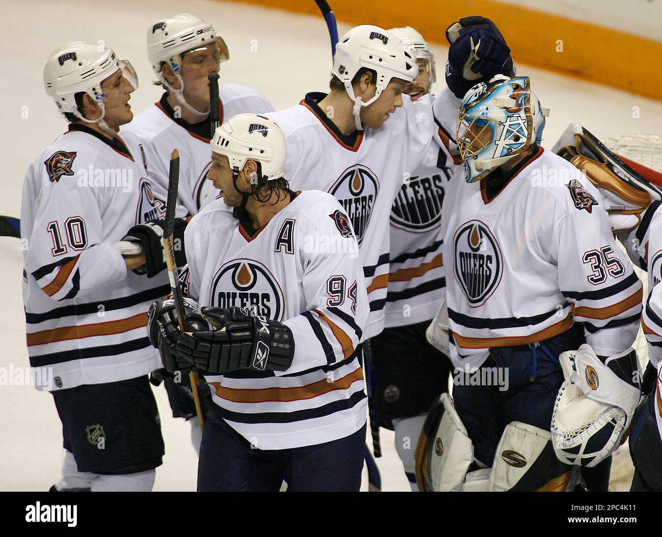 Edmonton Oilers goalie Dwayne Roloson, right, is congratulated by ...