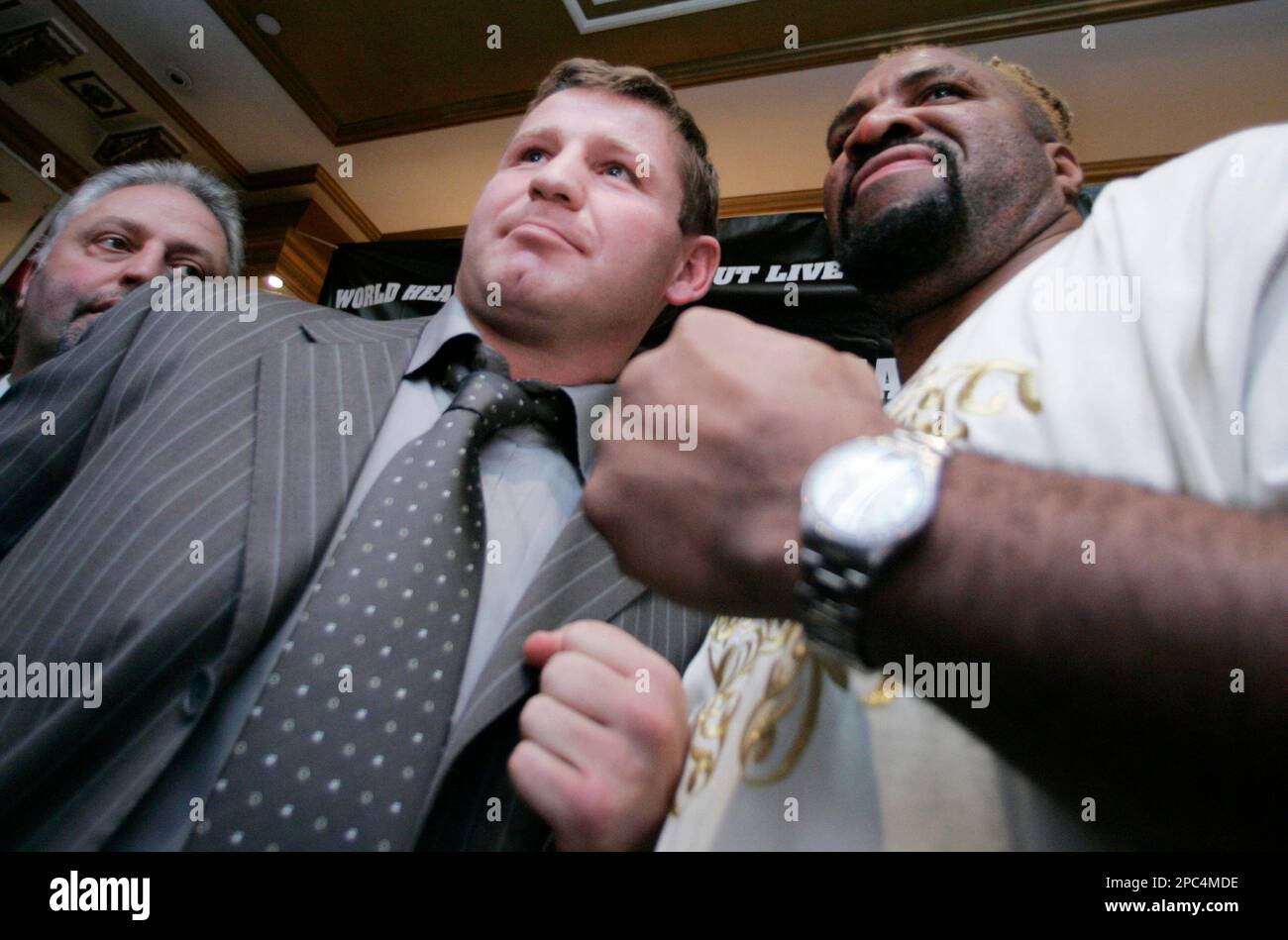 WBO heavyweight boxing champion Shannon Briggs, right, poses for photos ...