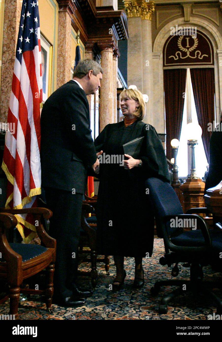 Iowa Supreme Court Chief Justice Marsha Ternus, right, is greeted by ...