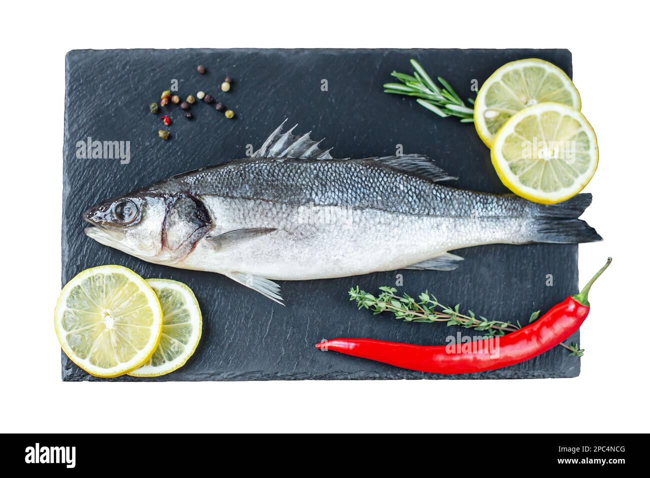 Fresh fish with spices and herbs on table in kitchen. Fresh sea bass ...