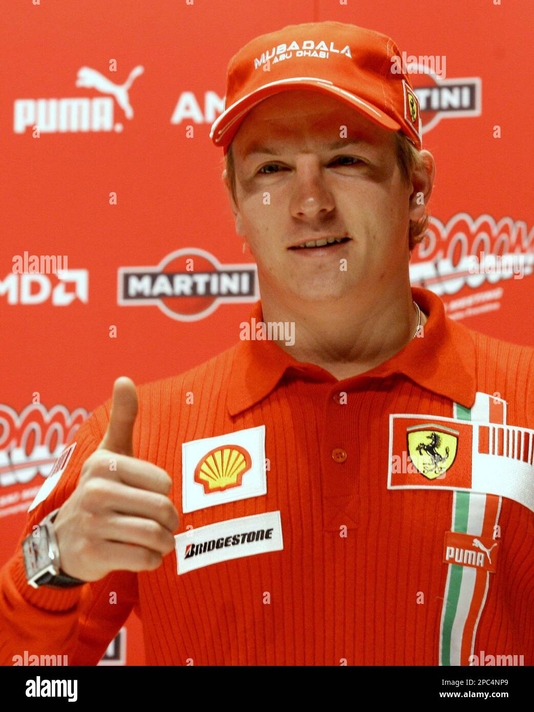 New Ferrari Formula One driver Kimi Raikkonen gestures during a press ...