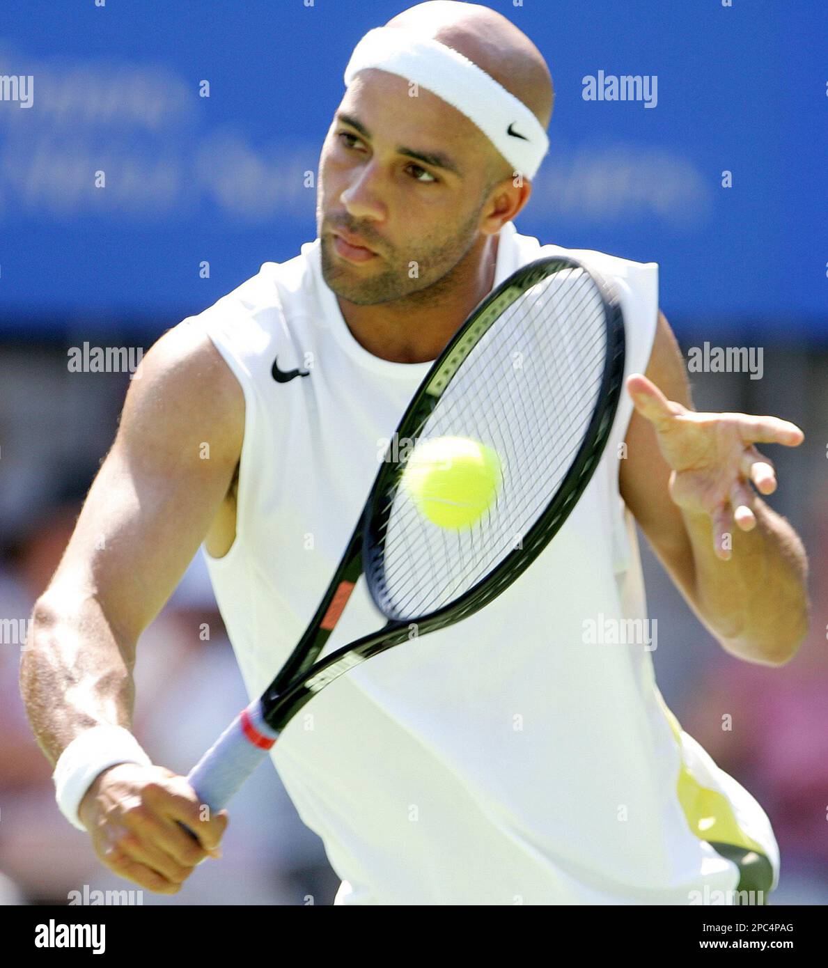 James Blake of the United States returns a shot during his third round ...