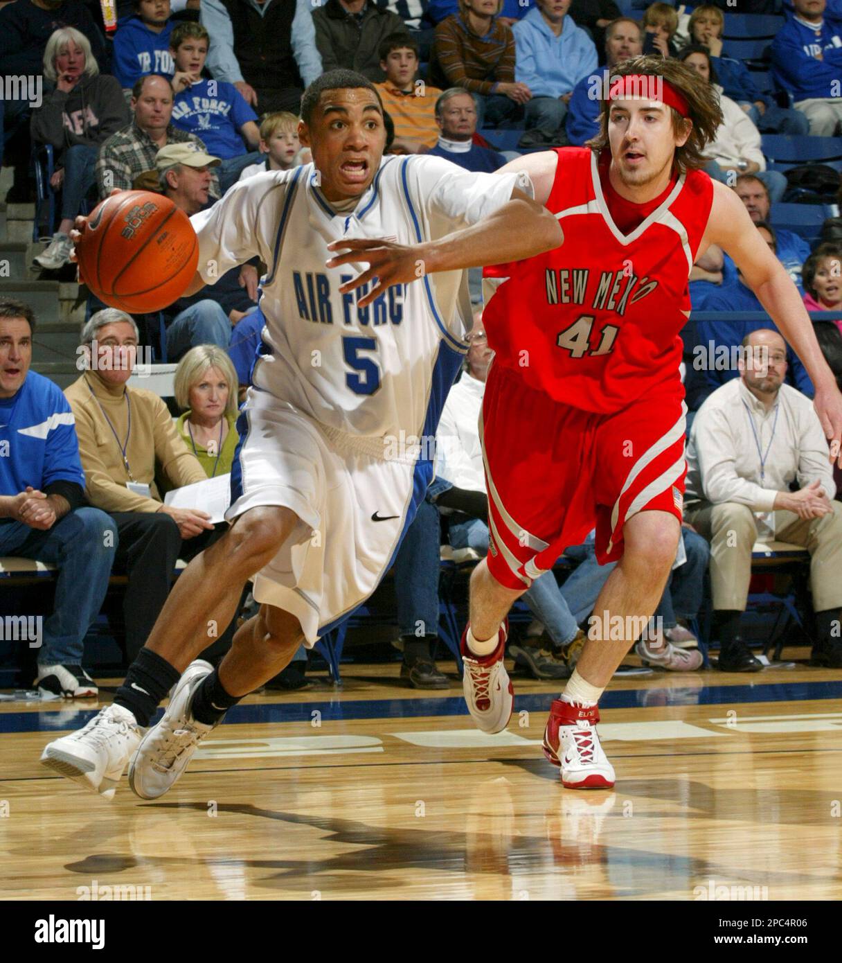 Air Force guard Matt McCraw (5) drives to the basket past New Mexico ...