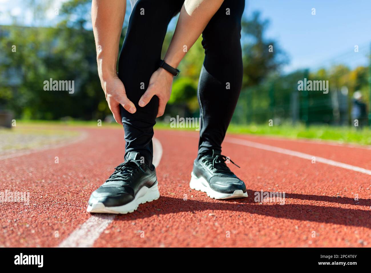 Sports injury, close-up photo of male runner's legs, athlete injured ...
