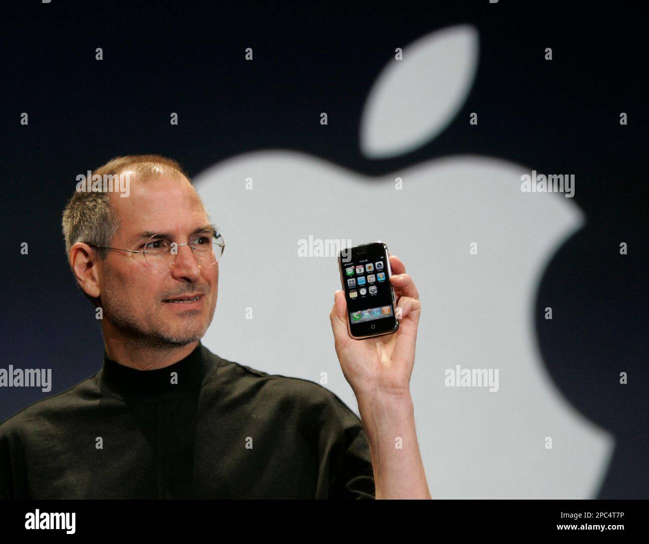 Apple CEO Steve Jobs holds up the new iPhone during his keynote address ...