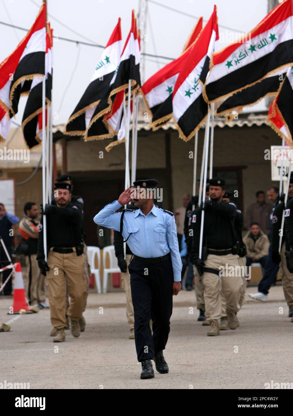 Iraqi policemen march during a ceremony marking the 86th anniversary of ...