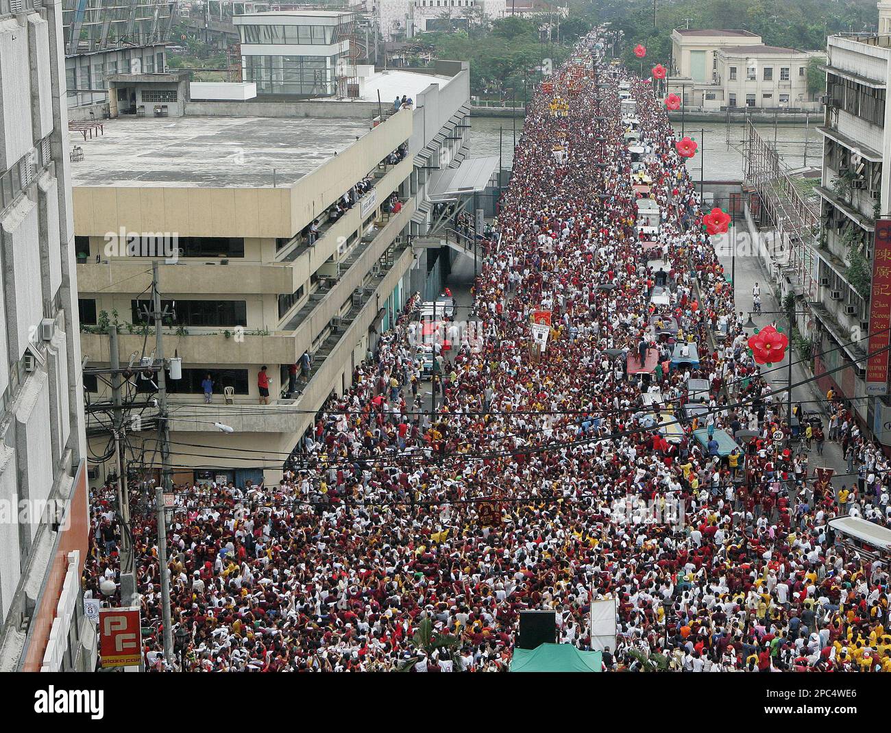Tens of thousands of devotees crowd a street as they join a procession to celebrate the 400th ...