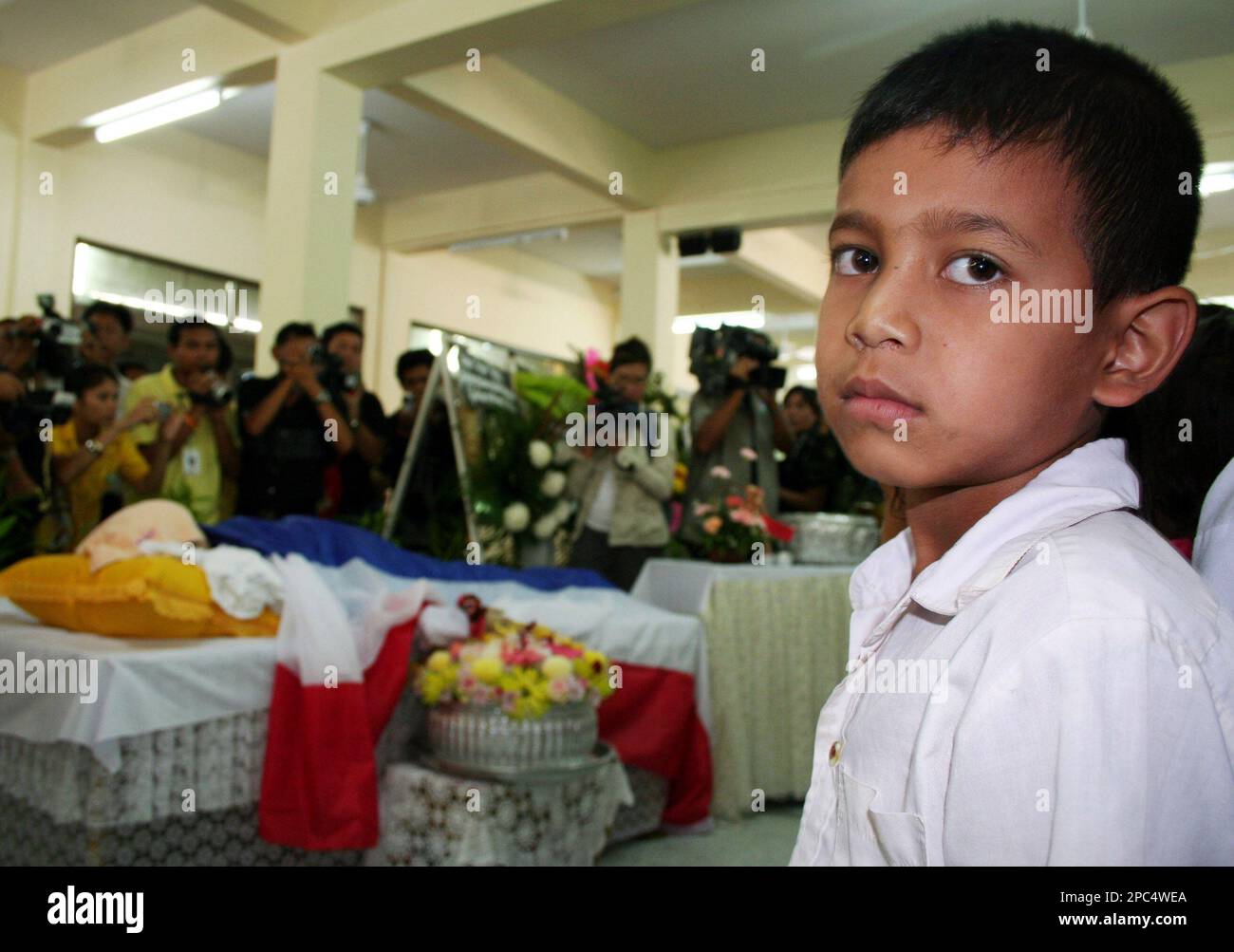 A Thai-Muslim school boy, right, attends religious rites for his ...
