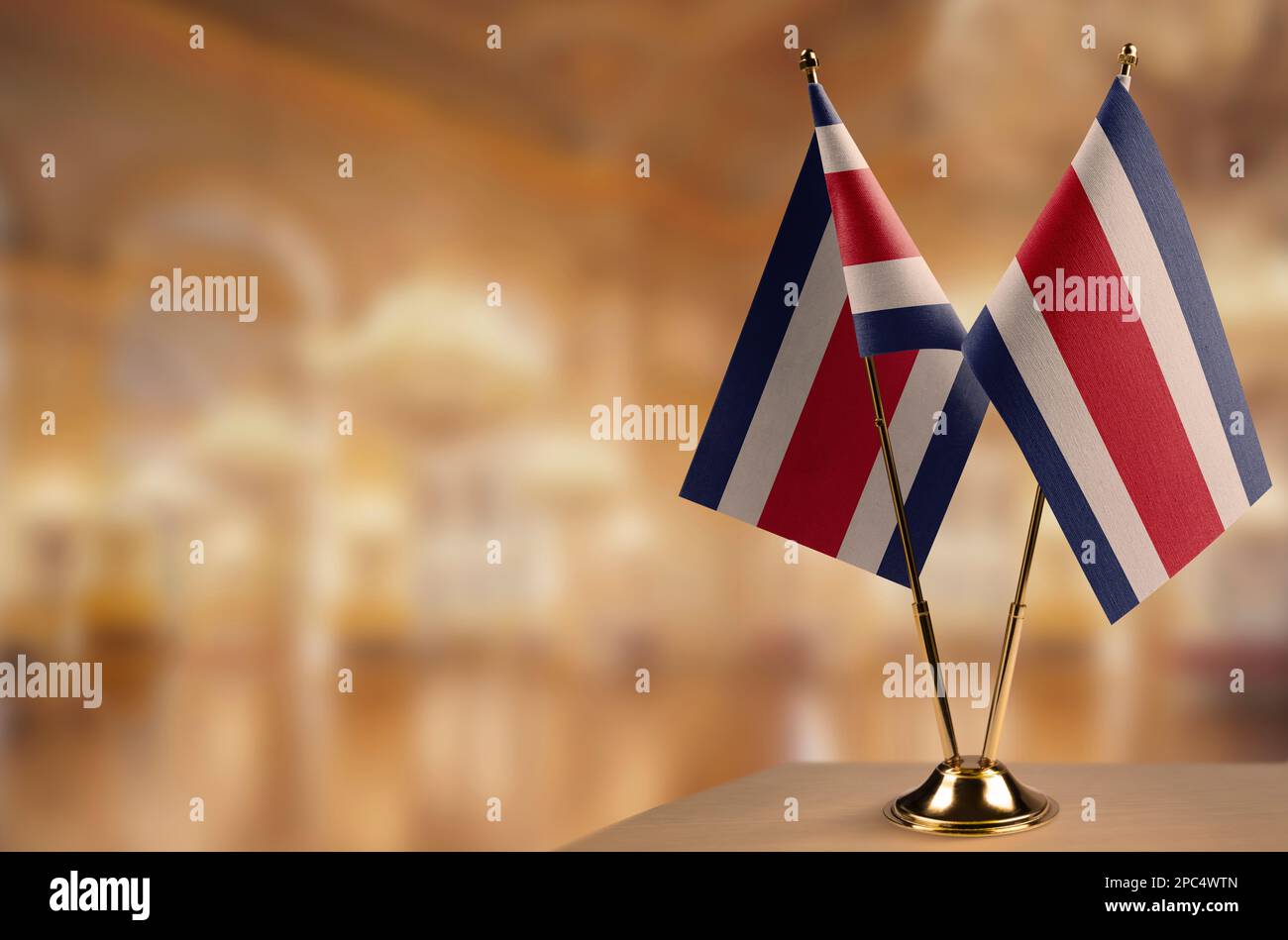 Small flags of the Costa Rica on an abstract blurry background Stock ...