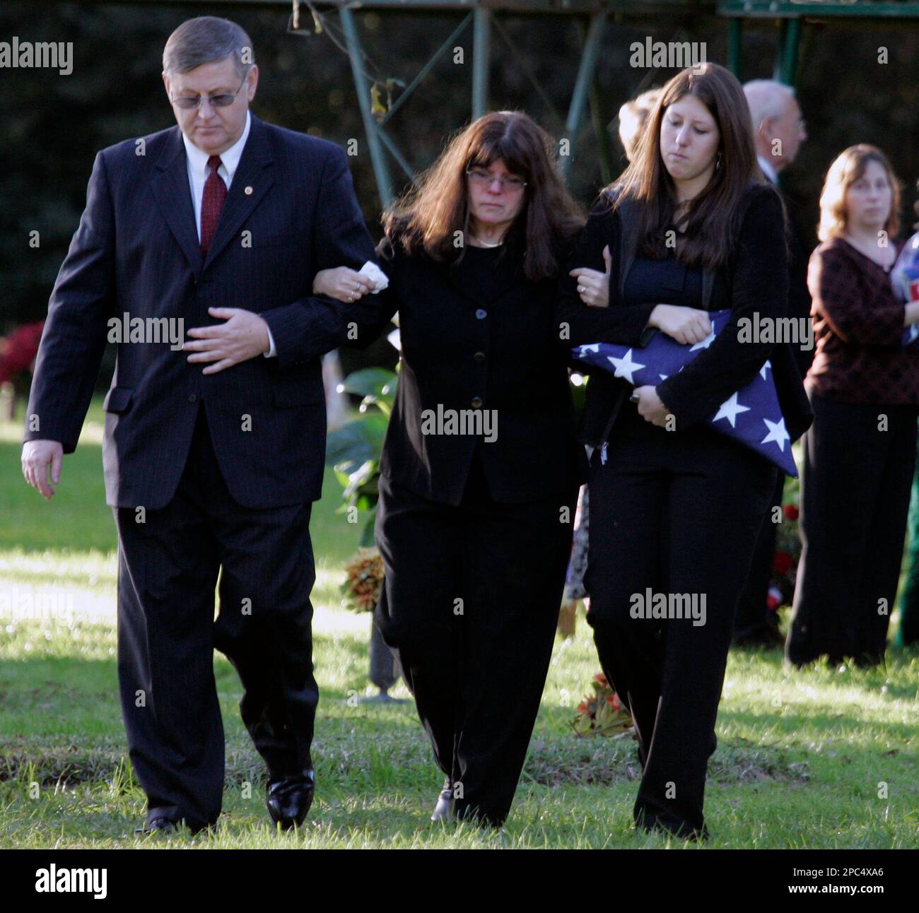 David and Judy Donica and their daughter Courtney leave the graveside ...