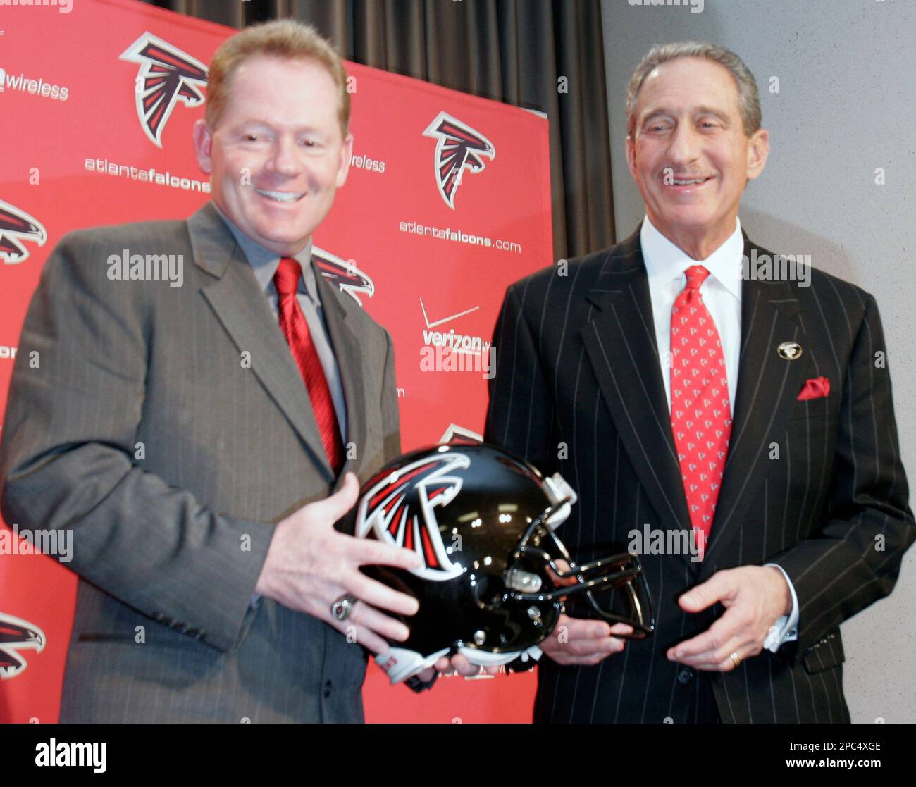 News Atlanta Falcons coach Bobby Petrino, left, holds a Falcons helmet ...